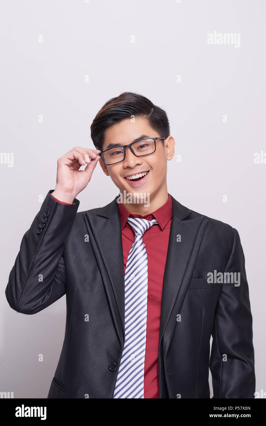 Handsome and well dressed businessman in a suit, tie and vest, standing ...