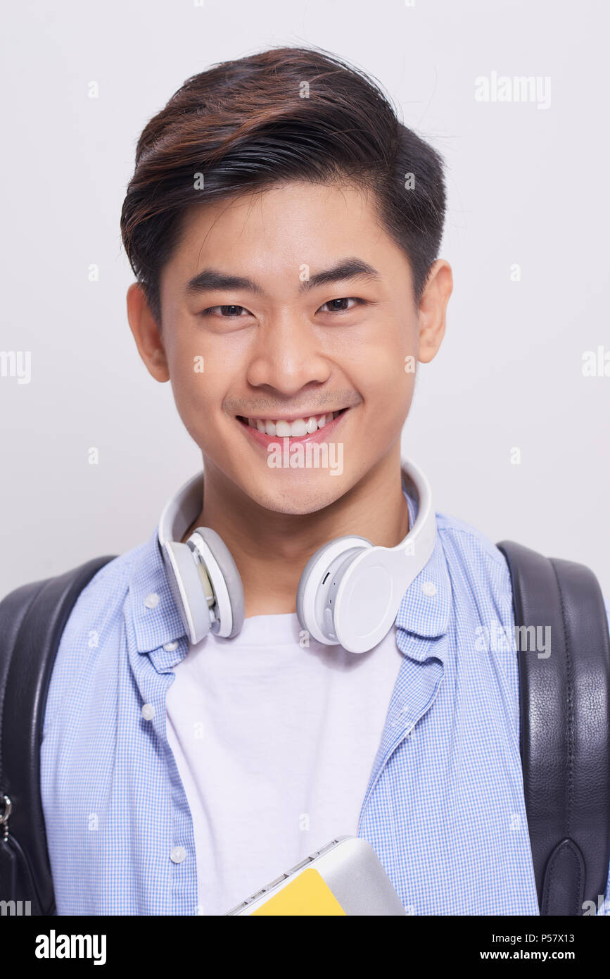 Close up portrait of a handsome young asian man smiling on isolated ...