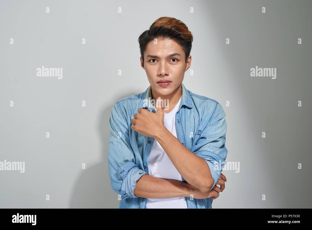 Portrait of handsome young asian guy posing in studio Stock Photo - Alamy
