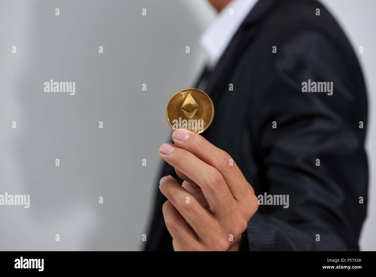 Golden Etherium in a man hand, Digitall symbol of a new virtual ...