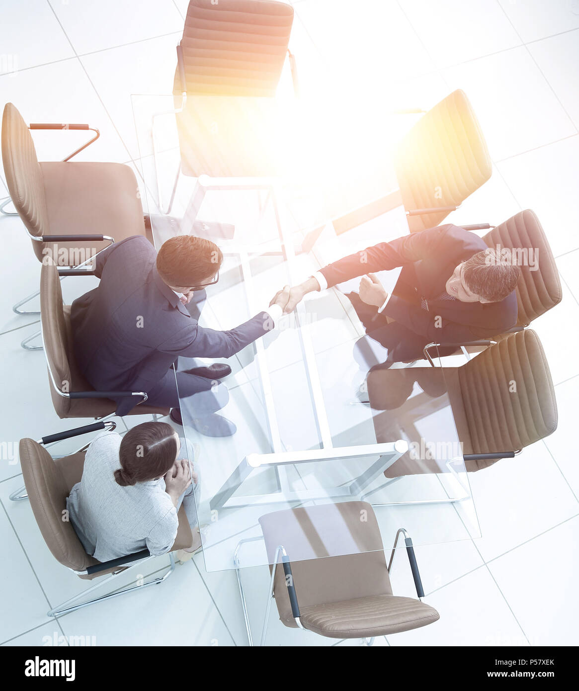 Handshake across table hi-res stock photography and images - Alamy