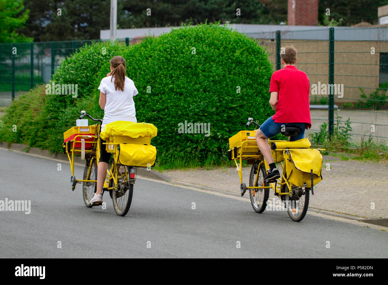 Postman riding his cargo bike carrying out mail in neighborhood Stock ...