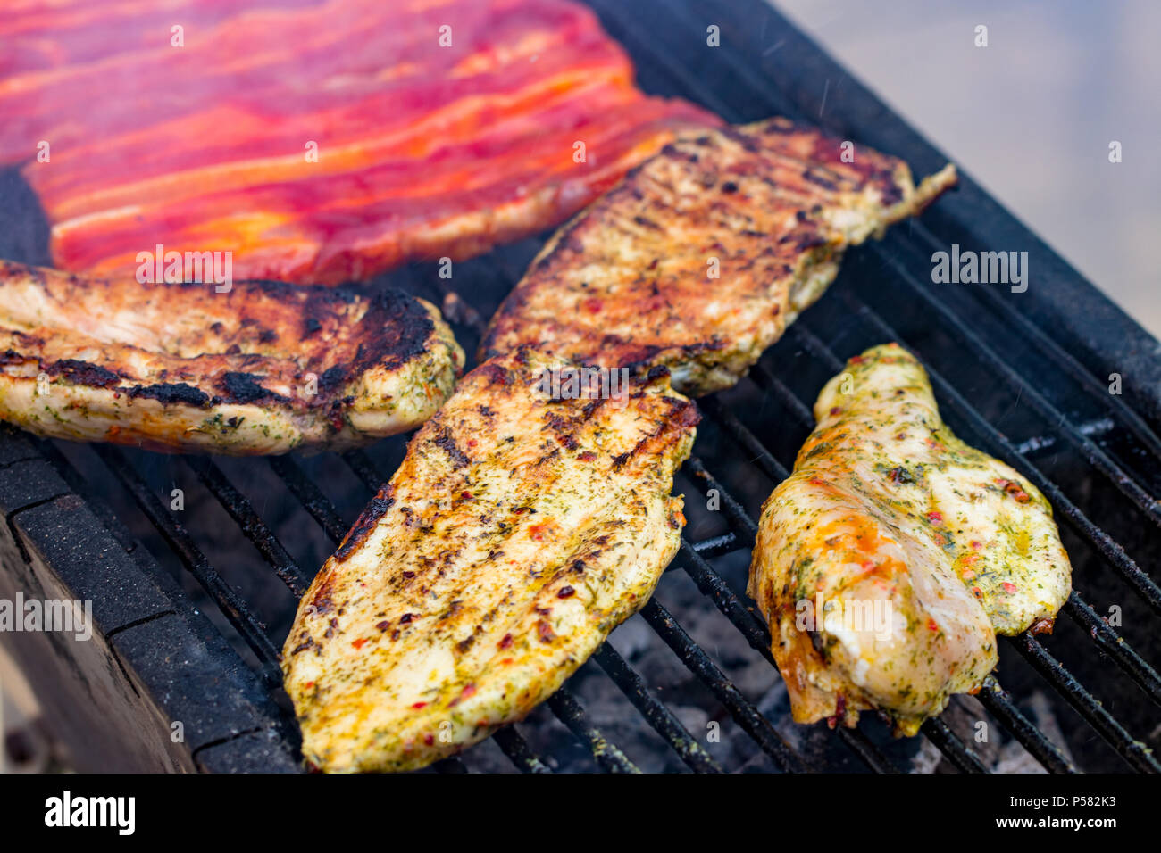 Assorted mixed grill from chicken meat, and pork, sausages roasting on ...