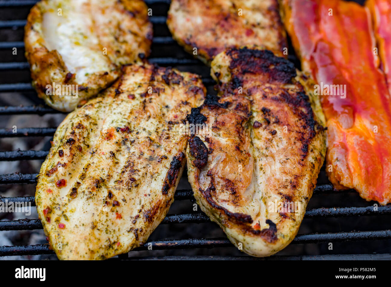 Assorted mixed grill from chicken meat, and pork, sausages roasting on ...