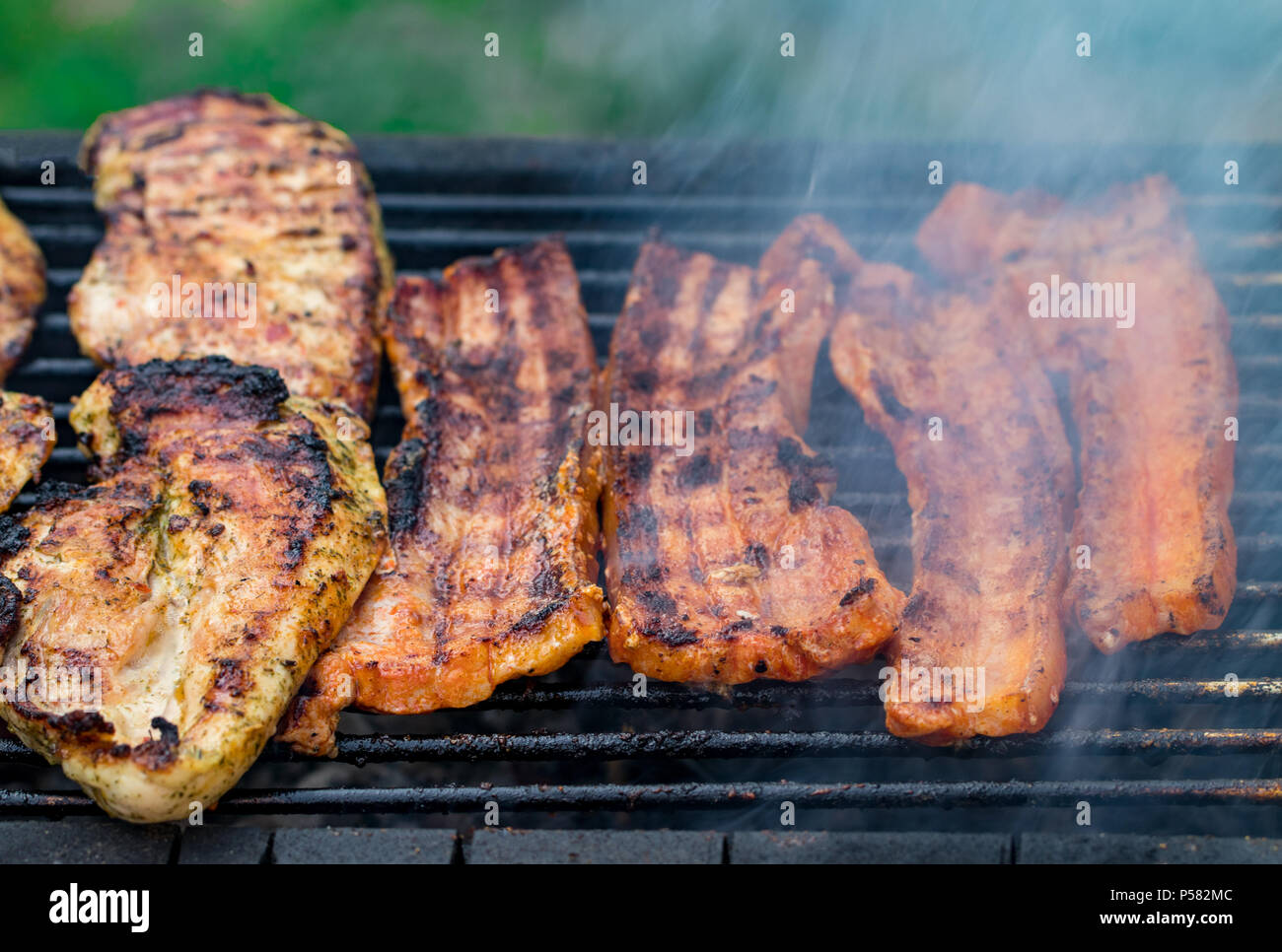 Assorted mixed grill from chicken meat, and pork, sausages roasting on ...