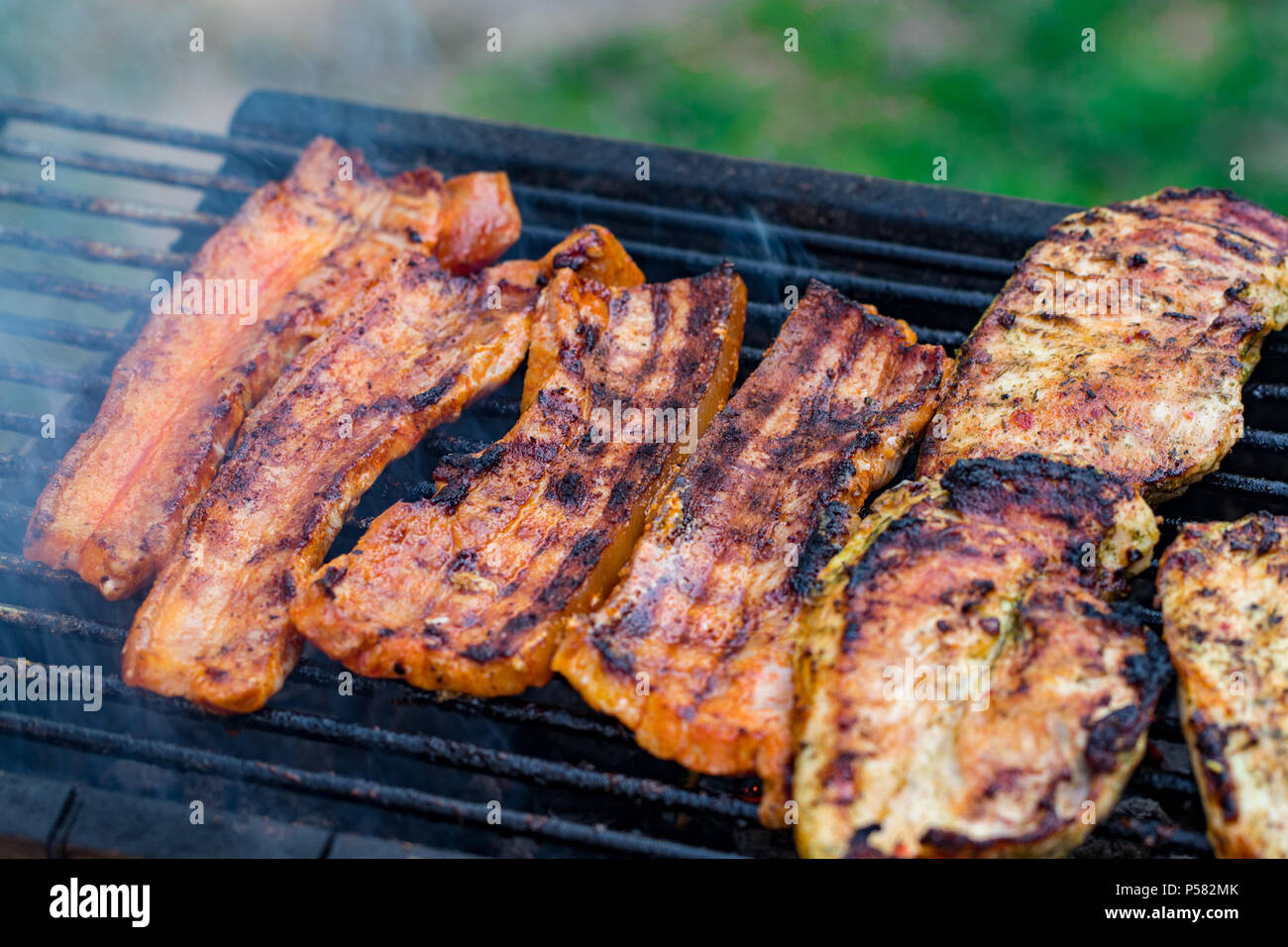 Assorted mixed grill from chicken meat, and pork, sausages roasting on ...