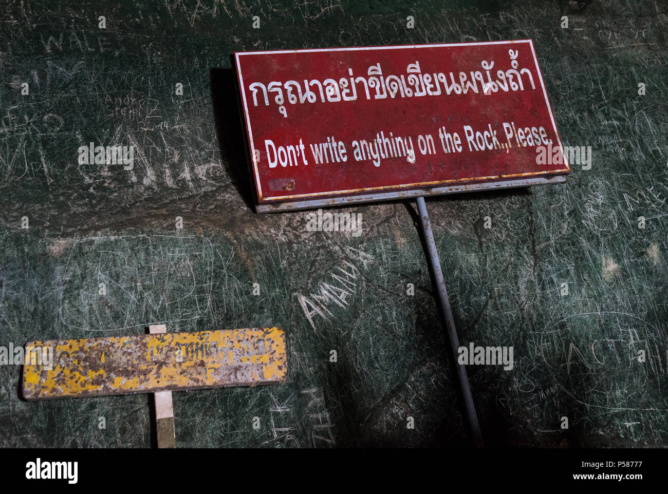 don't write anything on rock sign, next to text written on the rock ...