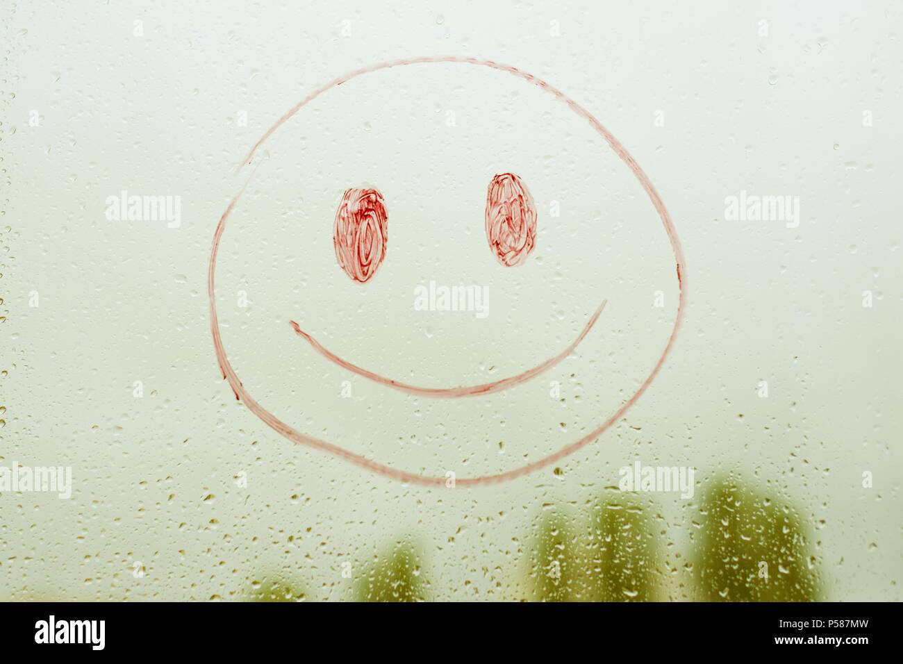 Positive funny smiley on a rainy window Stock Photo - Alamy
