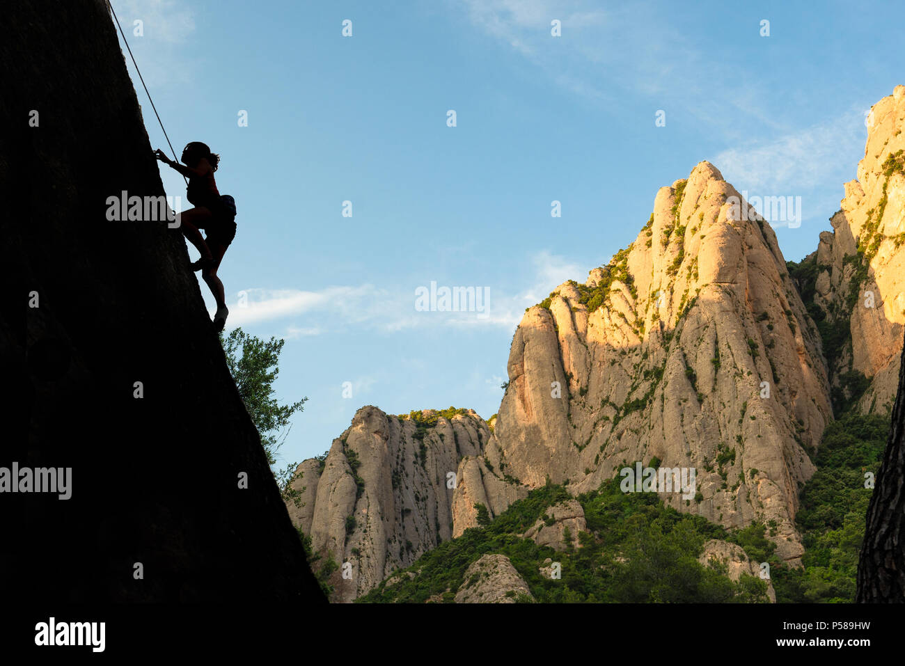 Girl climbing in the mountain of Montserrat, Spain Stock Photo - Alamy