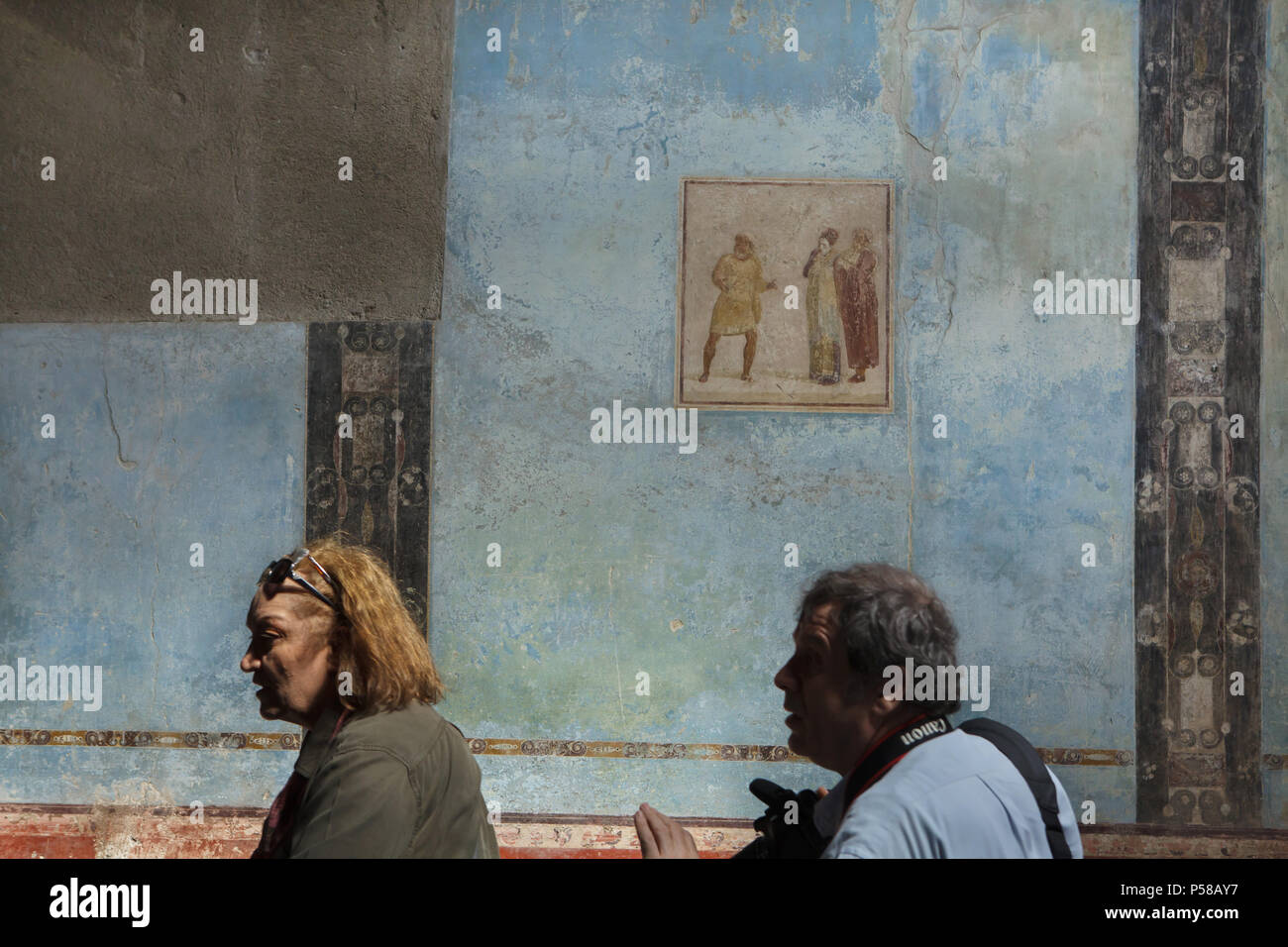 Visitors in front of the fresco in the third style with theatrical ...