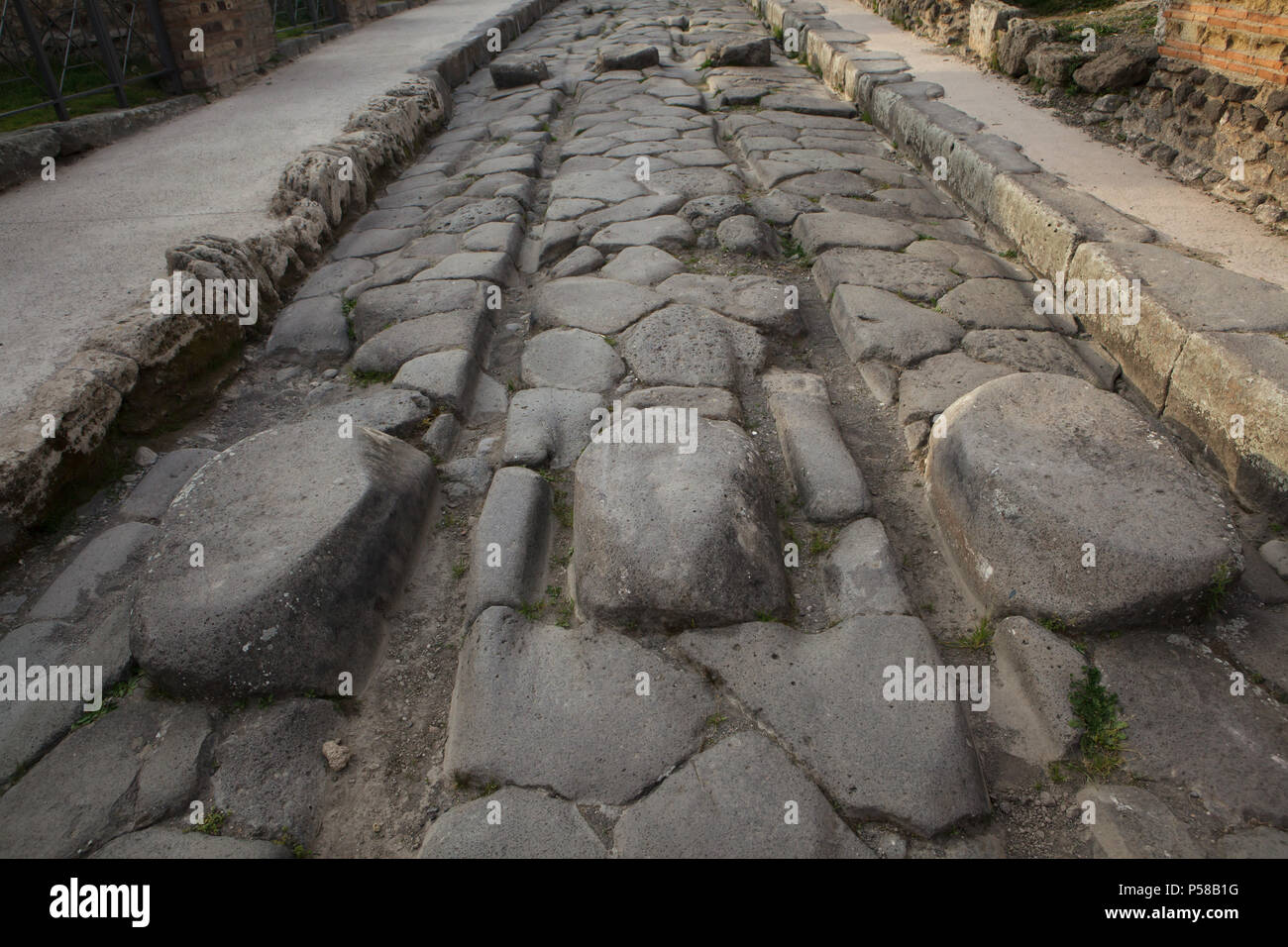 Traditional pedestrian crossing with gaps for chariots on the cobbled ...