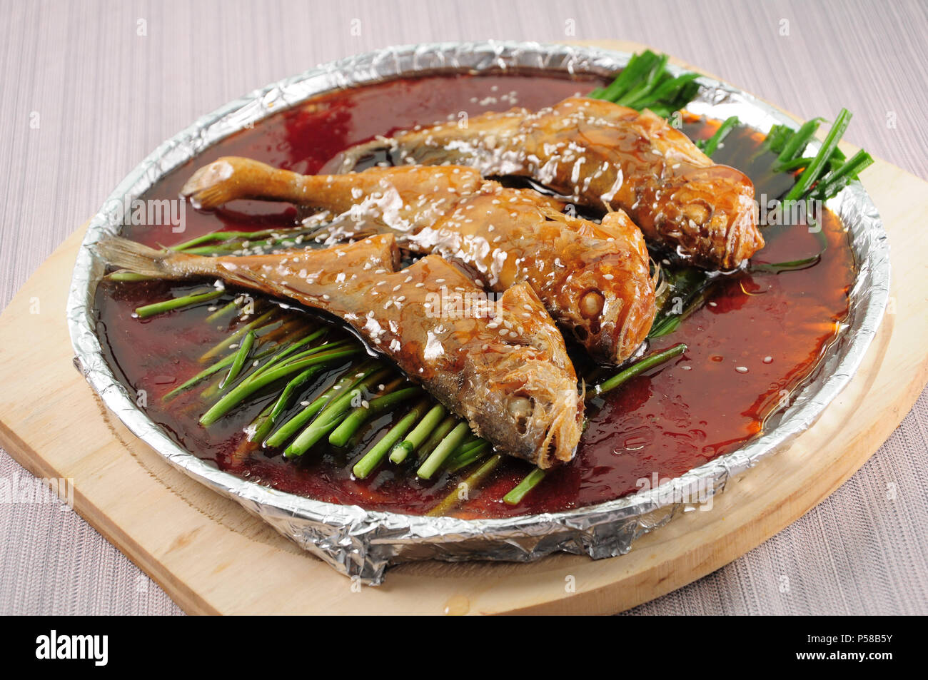 Chinese cuisine--Yellow Croaker on a Sizzling Iron Plate Stock Photo ...