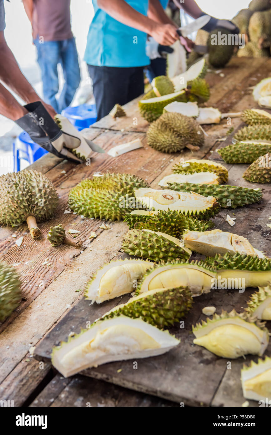 peeling durian by knife. Thai King fruit Stock Photo - Alamy