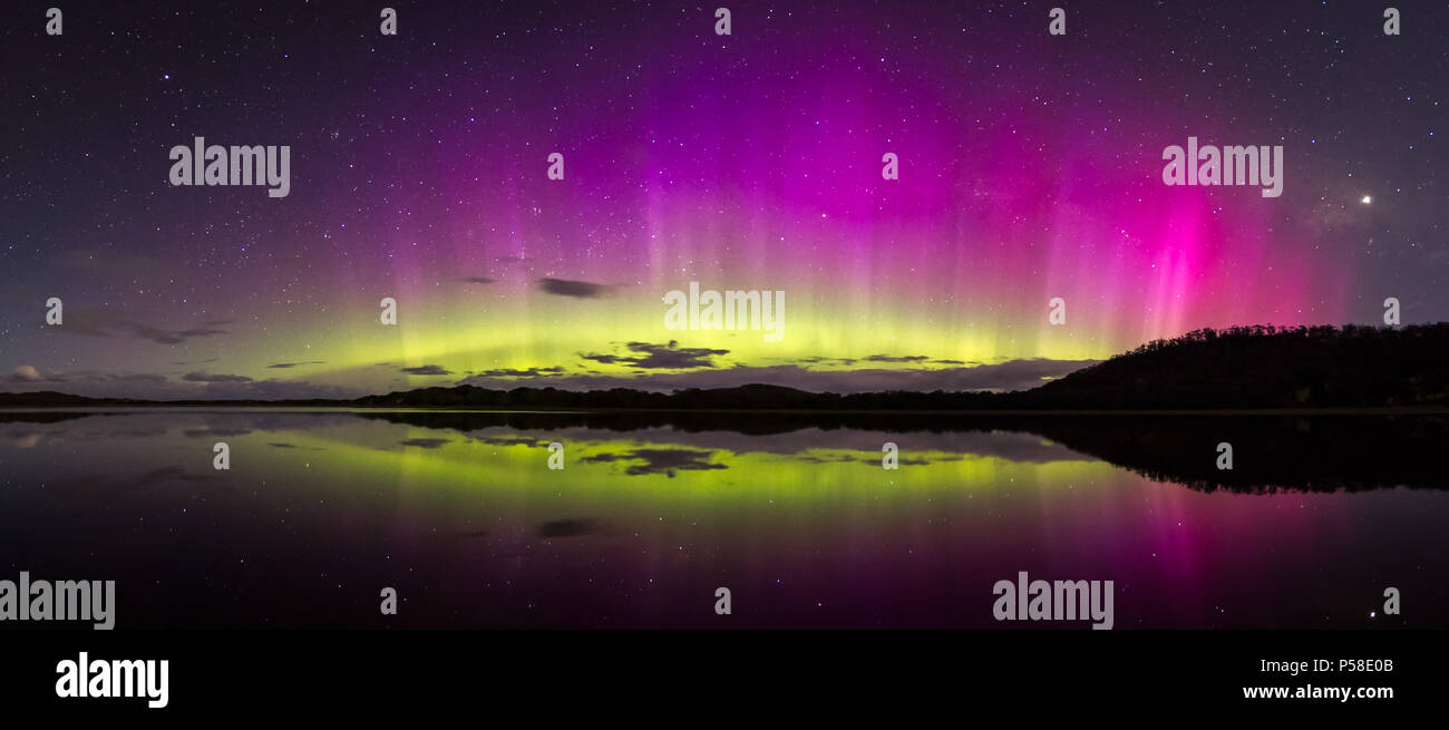 Bright and colourful aurora display with reflections Stock Photo - Alamy