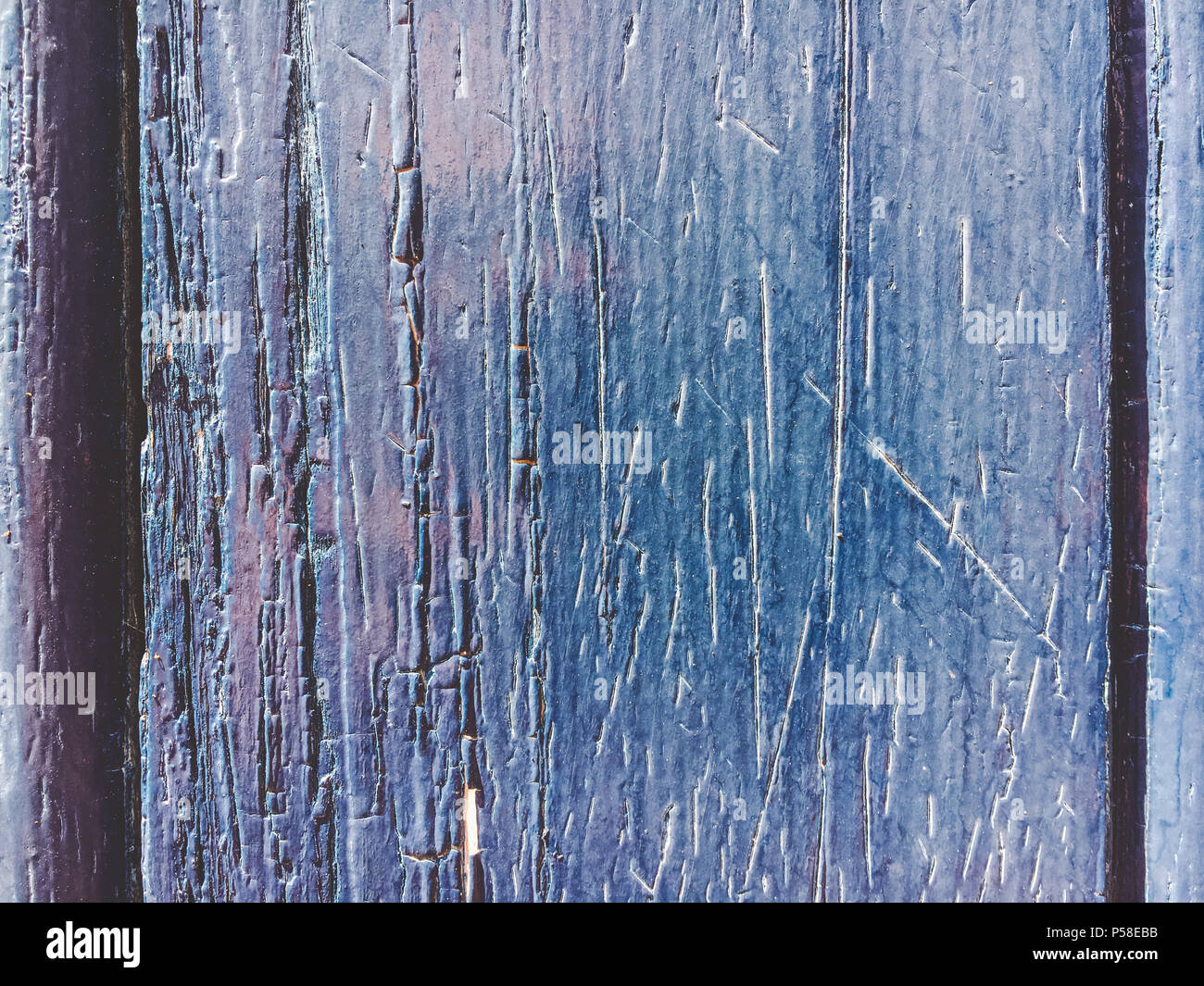 An old navy blue color of wooden wall with sun light for background ...