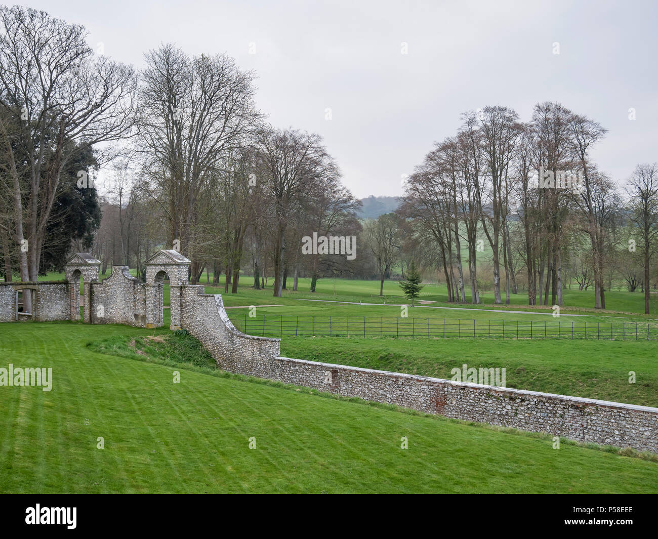 Country side view with a stone wall and gate at Chichester, United ...