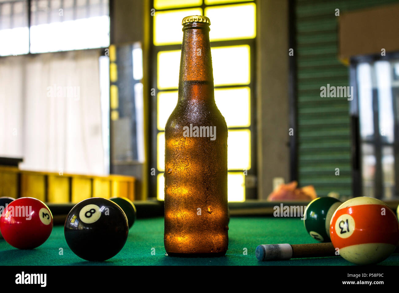 Frozen bottle of beer on a green billiard table, billiard balls Stock ...
