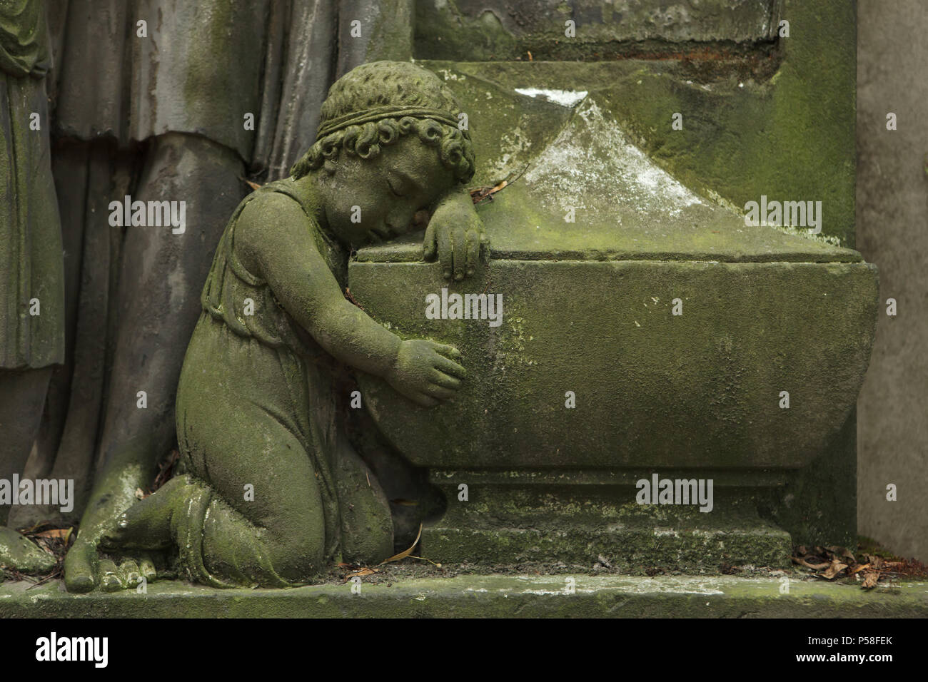 Child mourning over the coffin depicted on the abandoned tombstone of ...