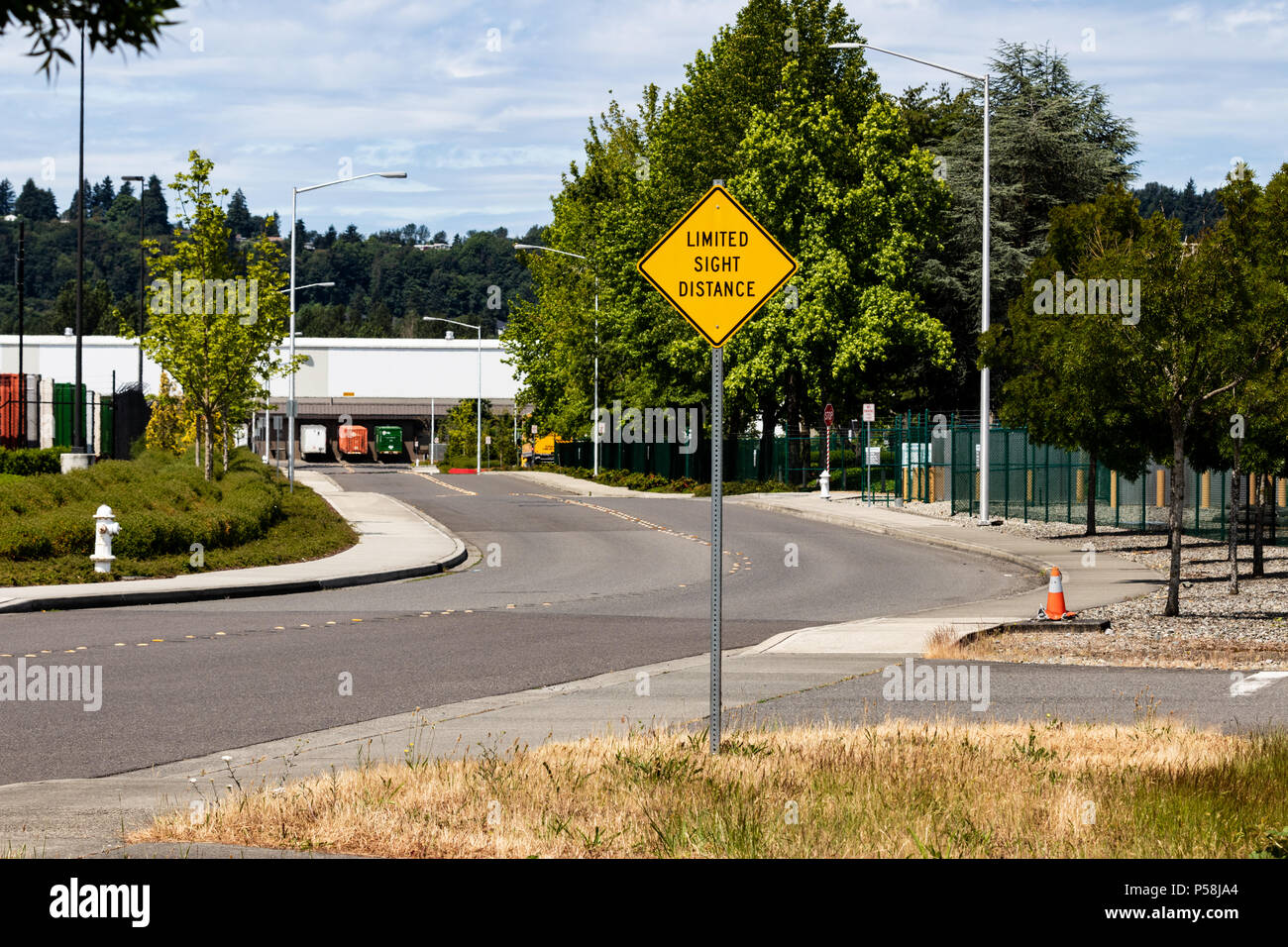 Limited Sight Distance sign on a road with trees and trailers Stock ...