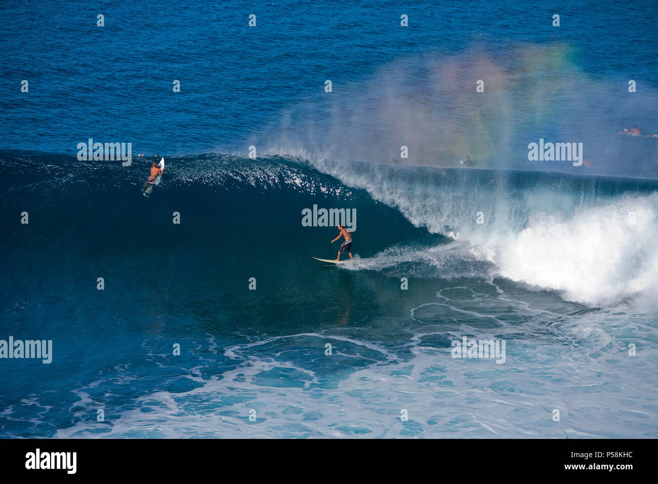 Surfer rides wave at Honolua Bay, Maui, Hawaii with faint rainbow in ...