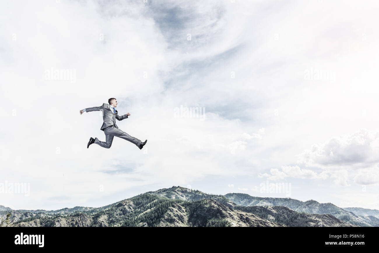 Businessman in suit running in the air as symbol of active life ...