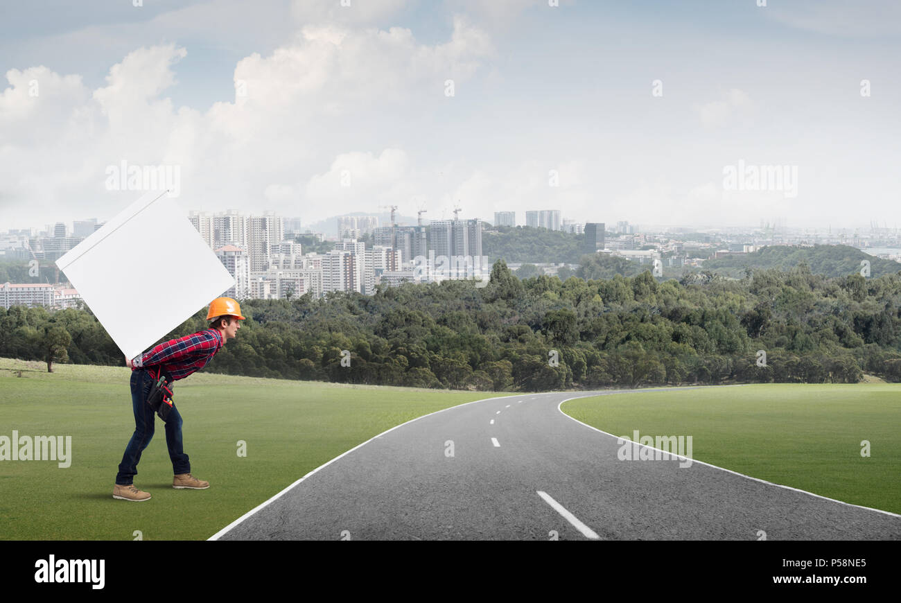 Man carrying on his back large box Stock Photo - Alamy
