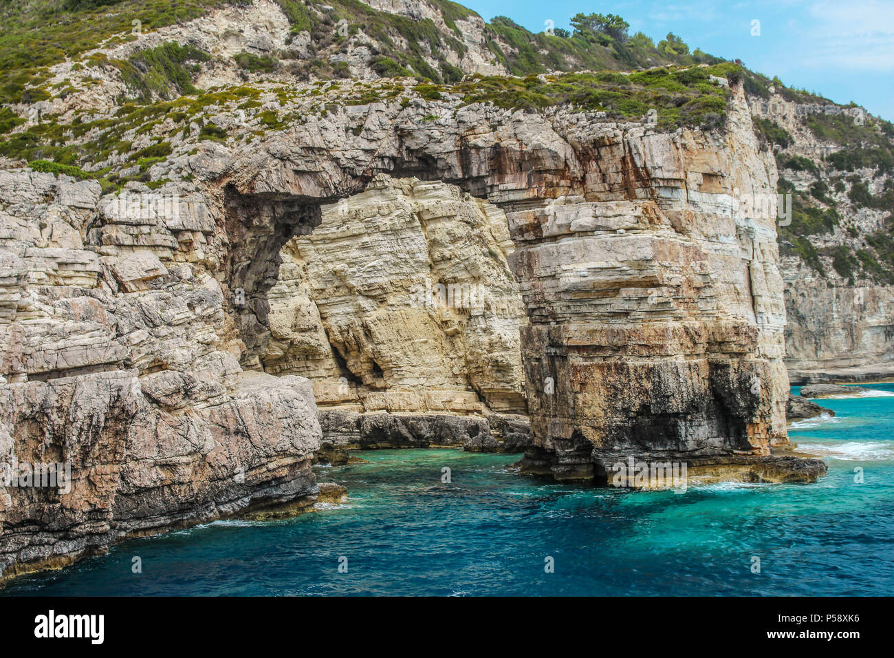 Natural rocky arch at Paxos (Paxi) island, called Trypitos, also known ...