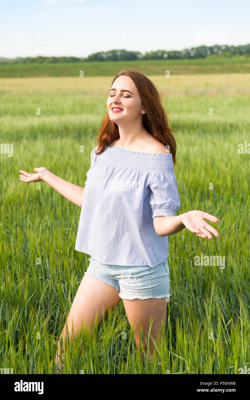 Beautiful happy girl enjoys the beauty of nature Stock Photo - Alamy