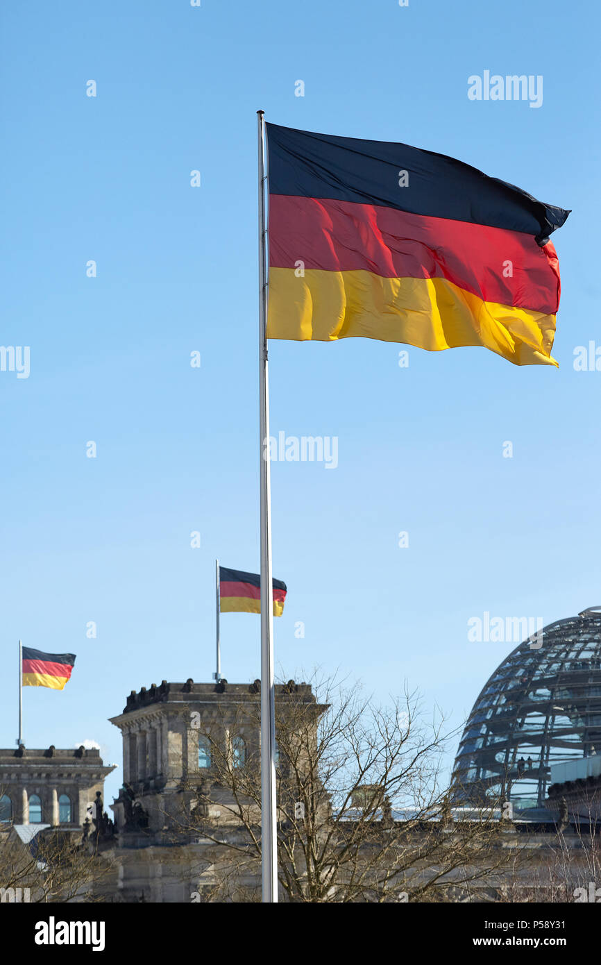 Berlin, Germany - The national flag of Germany. In the background the ...