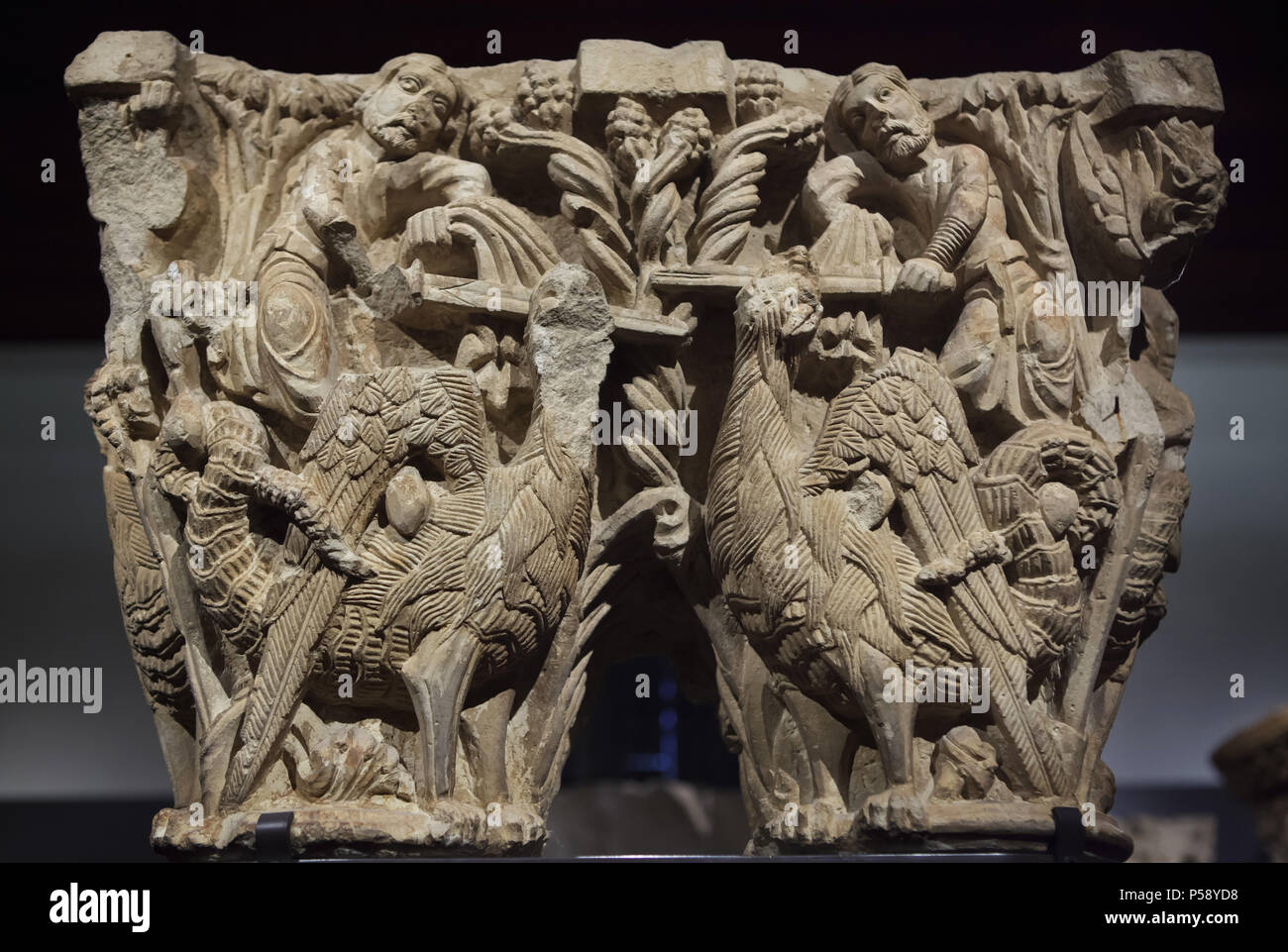 Human figures and basilisks depicted in the Romanesque double capital ...
