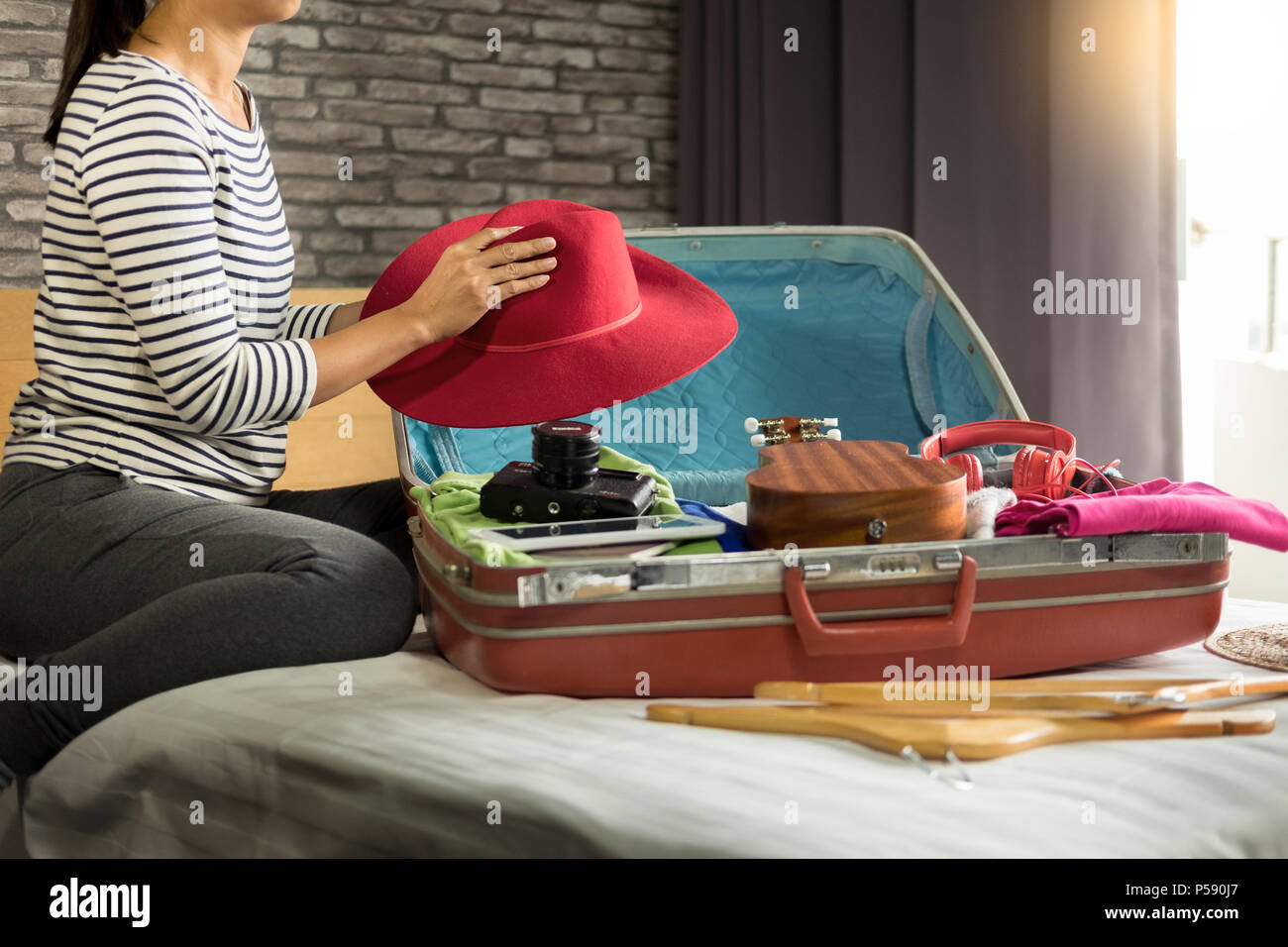Woman hand packing a luggage for a new journey and travel for a long ...