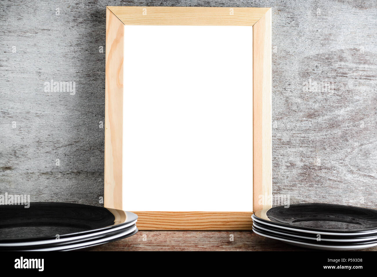 layout for design empty wooden frame isolated and plates on a wooden ...