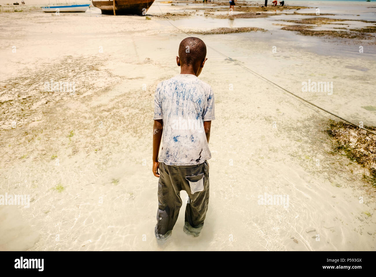 African child in search of seafood in the ocean Stock Photo - Alamy