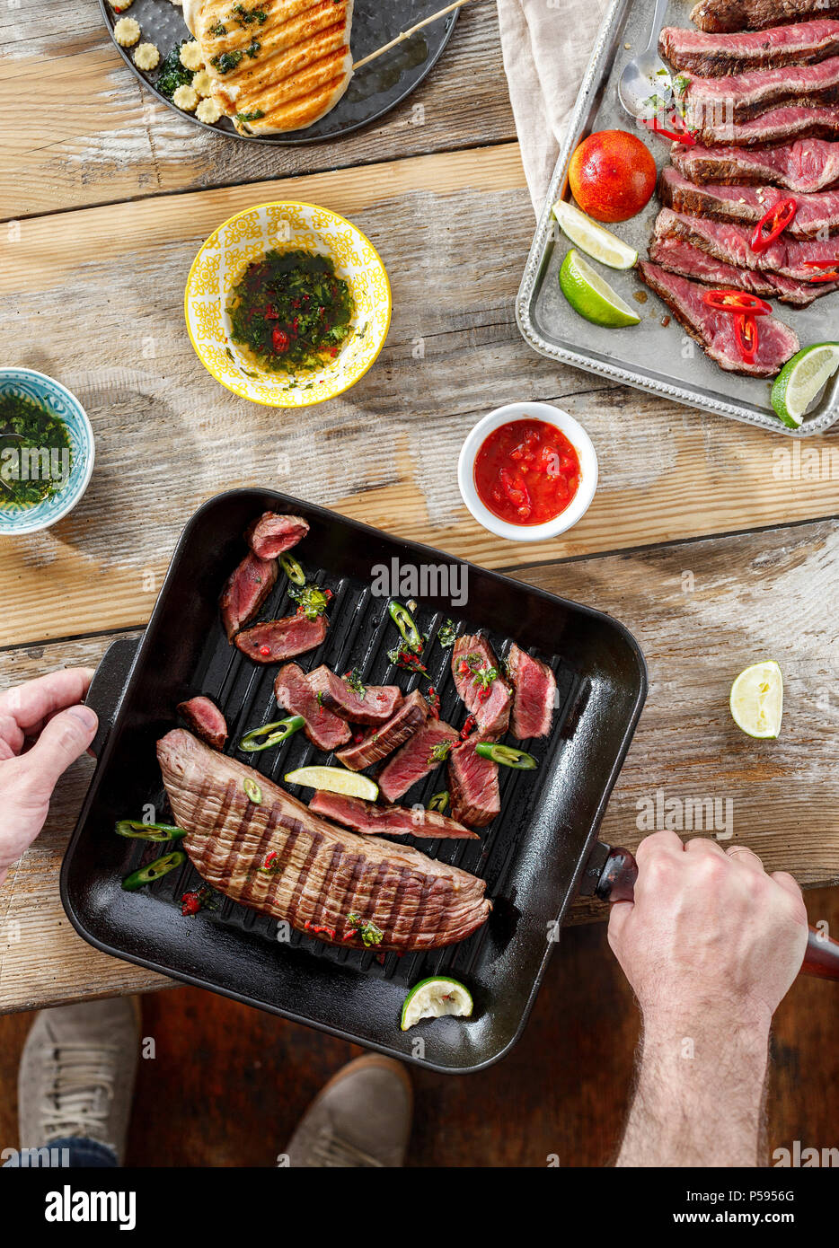 Top view dinner table concept. Beef steak grill and chicken steak grill ...