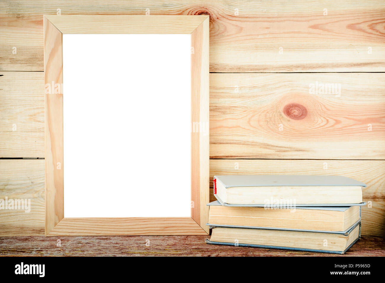 mockup wooden frame and old books on a wooden background. Layout for ...