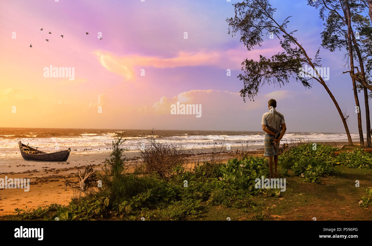 Rural fisherman at the beach at sunrise with view of wooden fishing ...