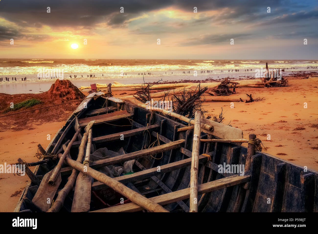 Wooden fishing boat on sea shore at sunset. Photograph shot at the ...