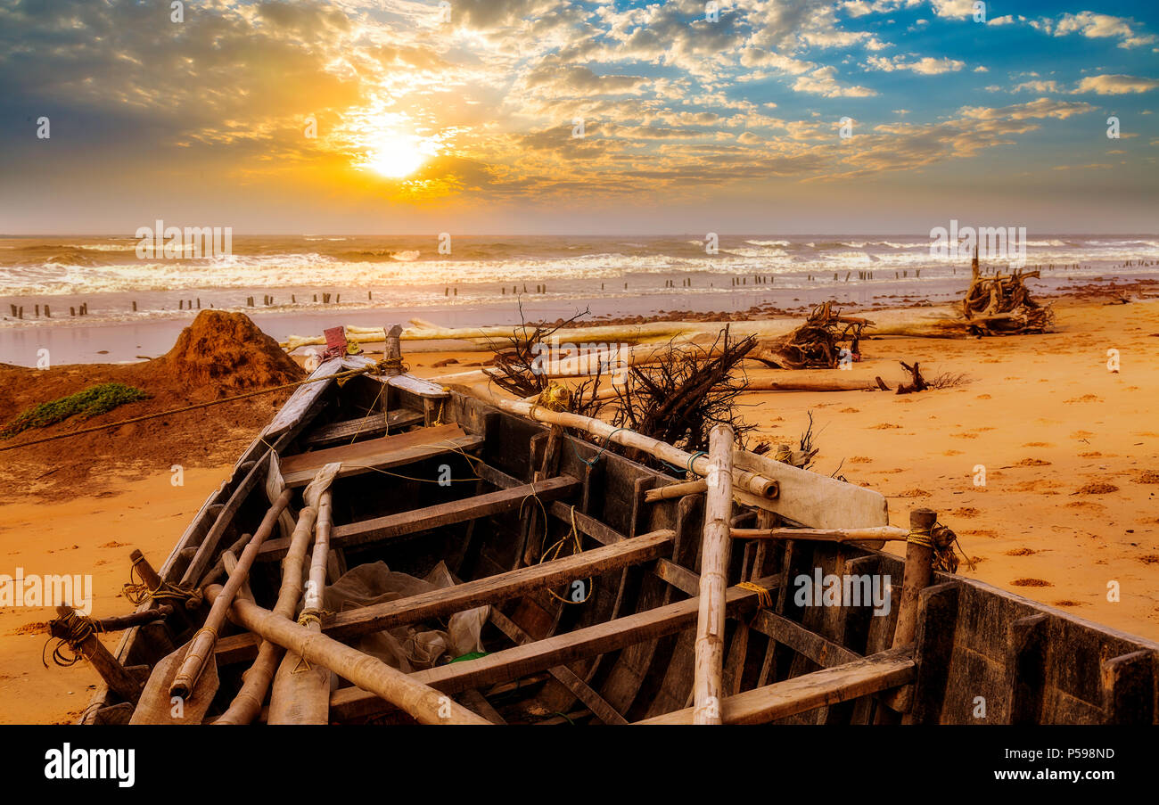 Wooden fishing boat on sea shore at sunset. Photograph shot at the ...