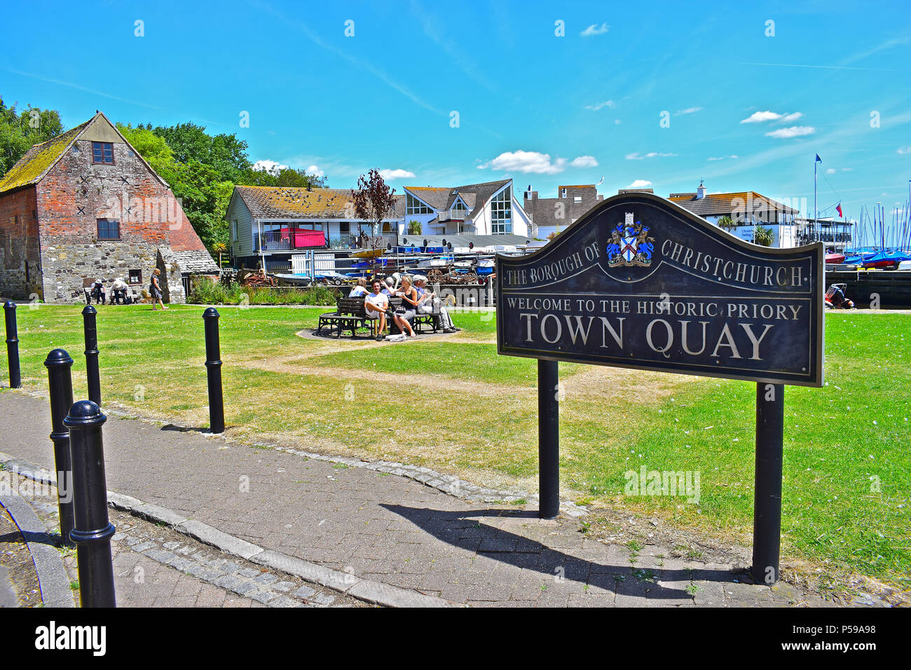 People relaxing in the summer sunshine at Town Quay in Christchurch ...
