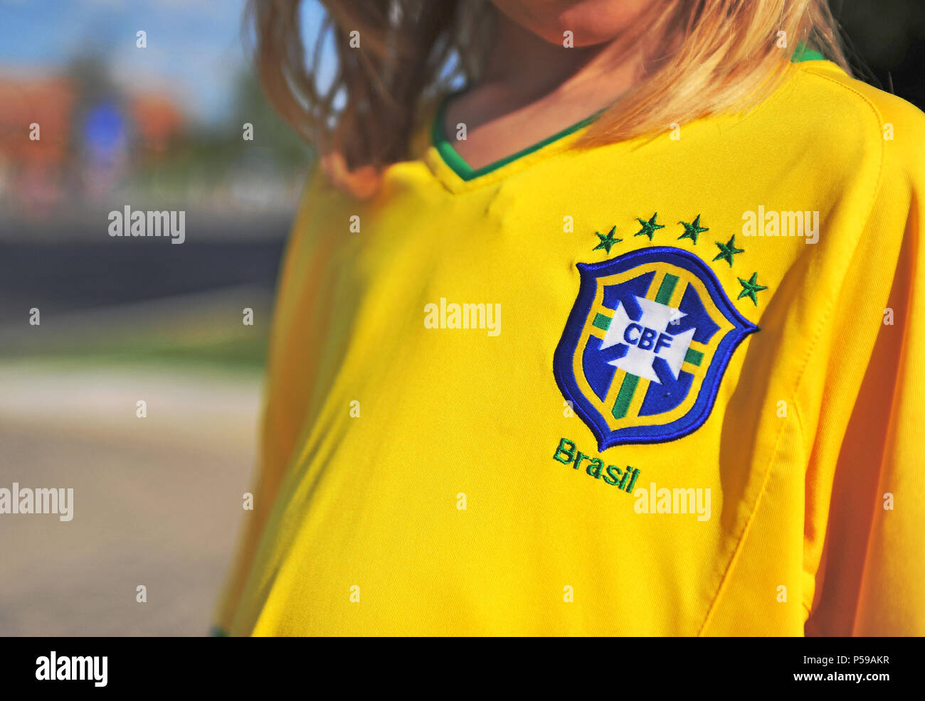 Kid wearing yellow football shirt of Brasil national team Stock Photo ...