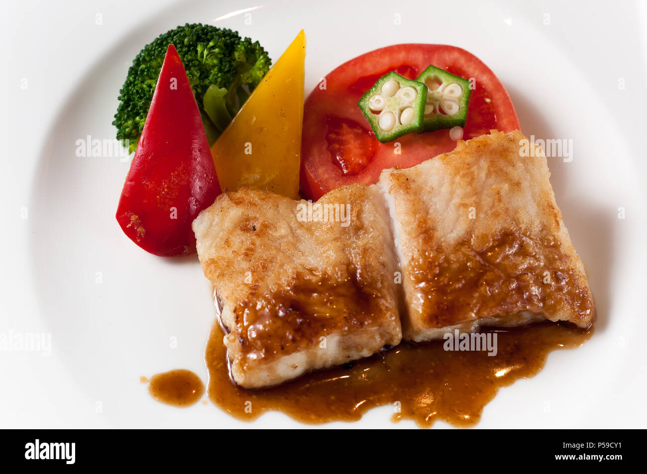 Fried fish with onion sauce Stock Photo - Alamy