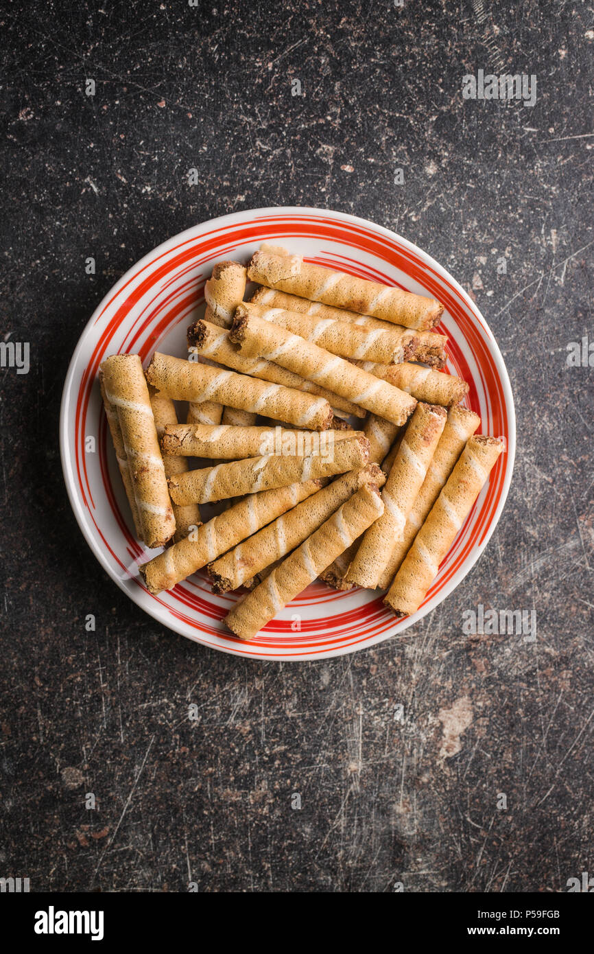Sweet chocolate waffle rolls on plate Stock Photo - Alamy