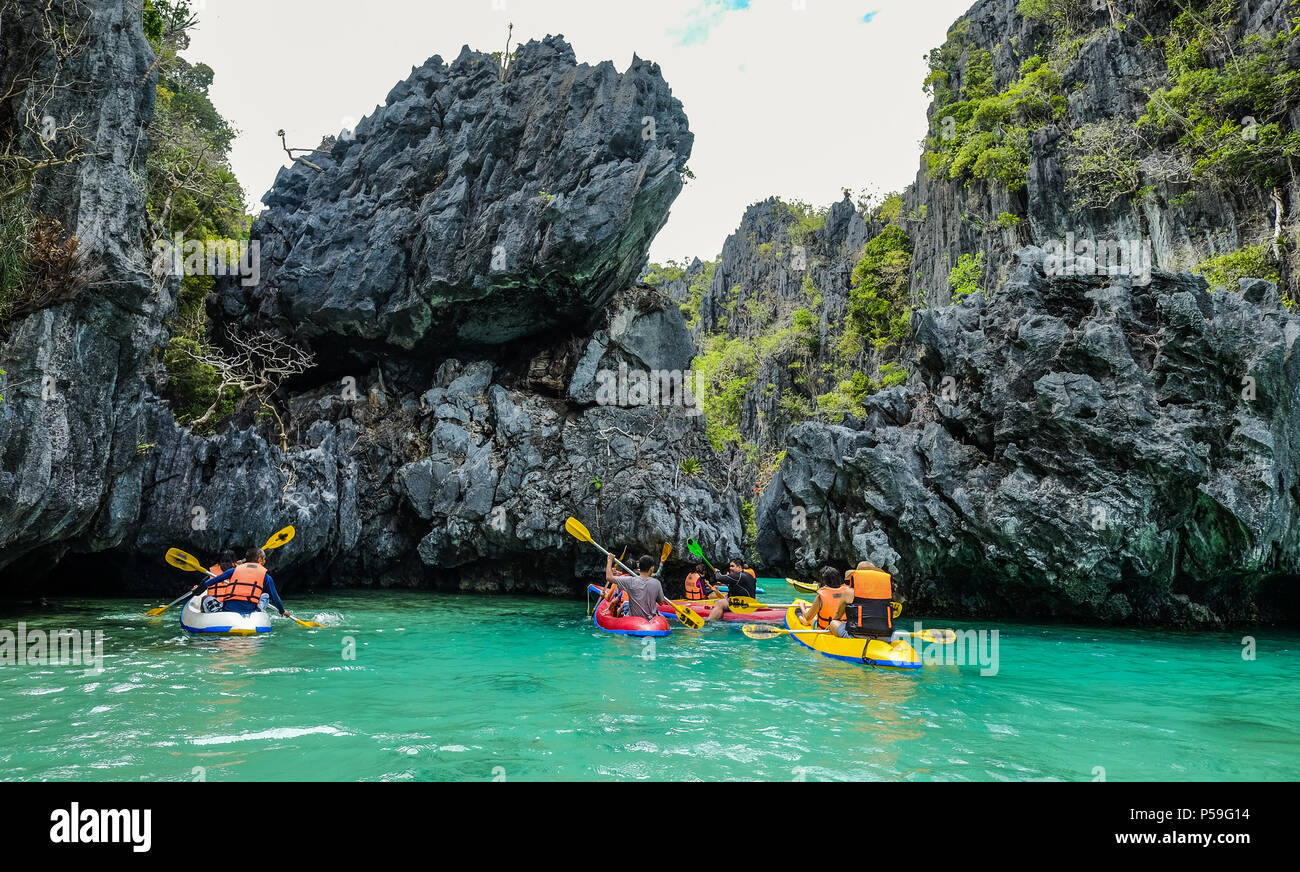 Palawan, Philippines - Apr 5, 2017. Tourists paddling kayak on blue sea ...