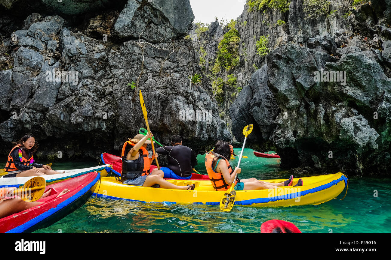 Palawan, Philippines - Apr 5, 2017. Tourists paddling kayak on blue sea ...