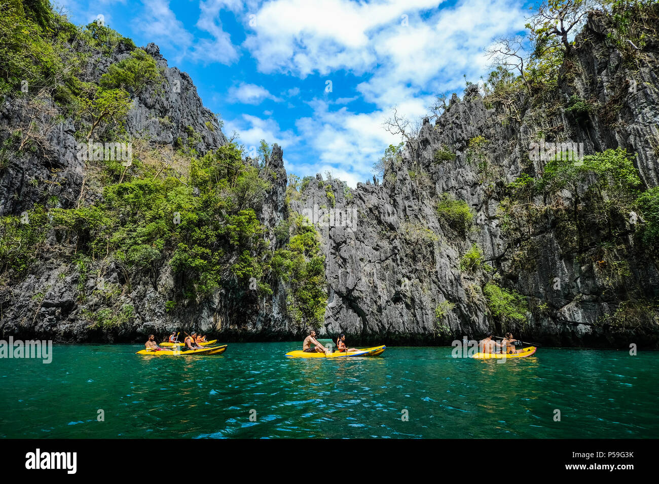 Palawan, Philippines - Apr 5, 2017. Tourists paddling kayak on blue sea ...