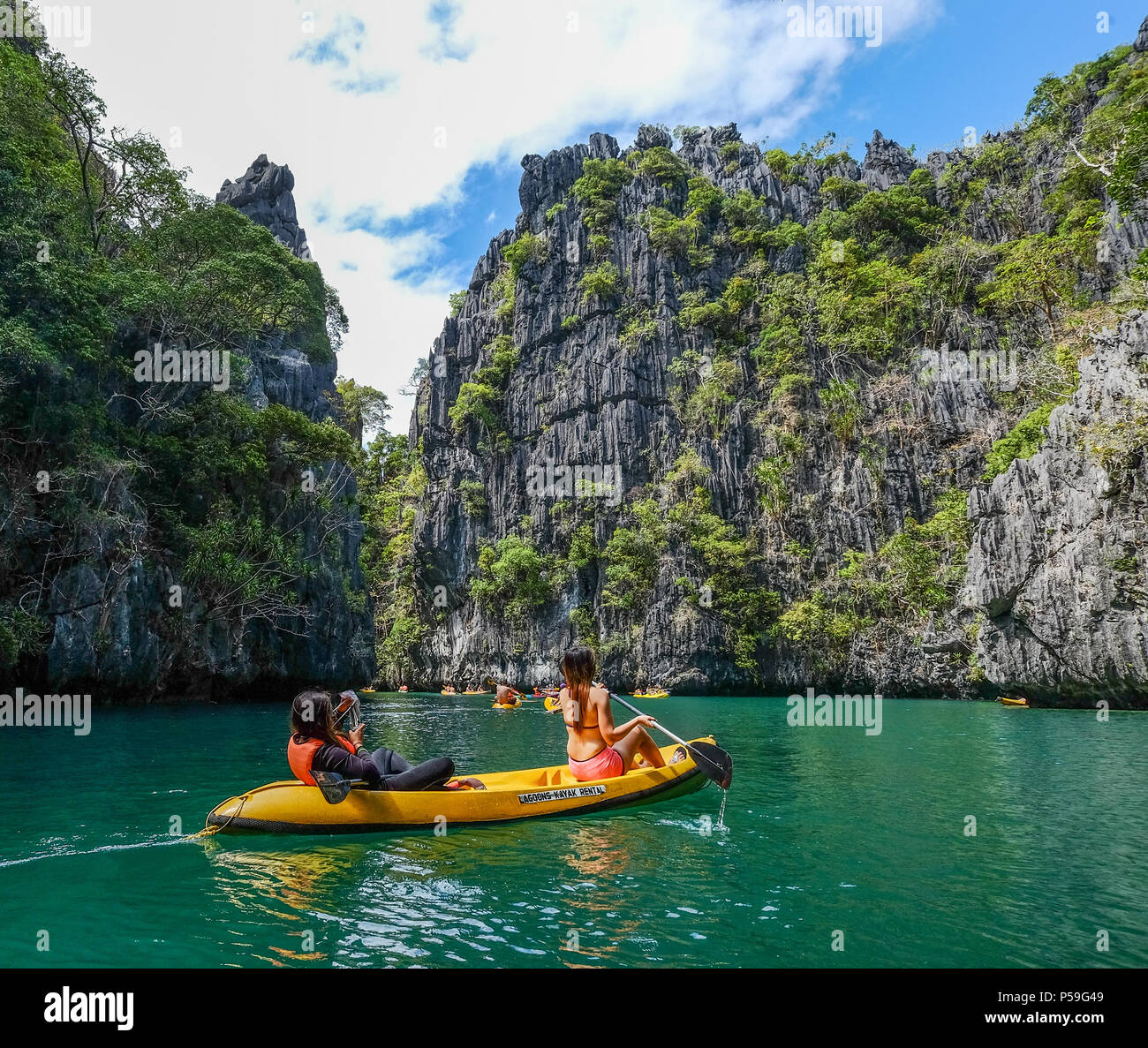 Palawan, Philippines - Apr 5, 2017. Tourists paddling kayak on blue sea ...