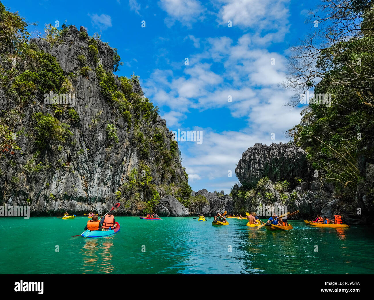 Palawan, Philippines - Apr 5, 2017. Tourists paddling kayak on blue sea ...