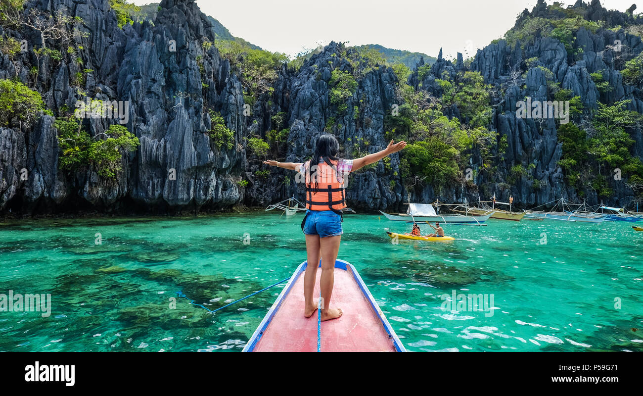 Palawan, Philippines - Apr 5, 2017. A woman standing on wooden boat in ...