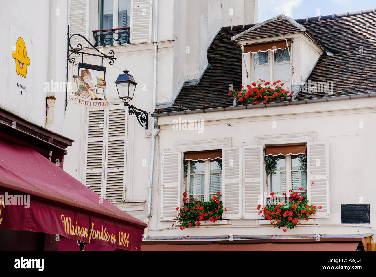 Paris, France - August 10, 2017. Typical Paris mansard windows on white ...