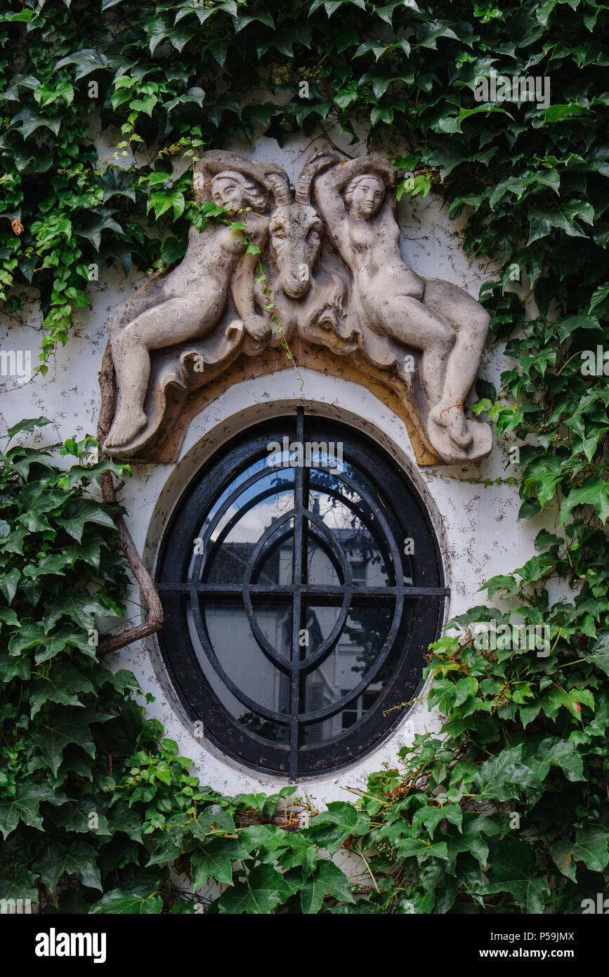 Paris, France - August 10, 2017. Oval window decorated with sculptures ...